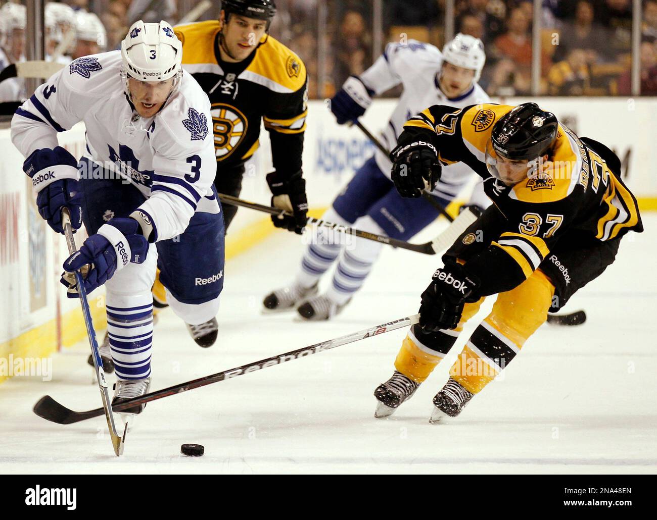 Toronto Maple Leafs' Dion Phaneuf tries to keep the puck away from ...
