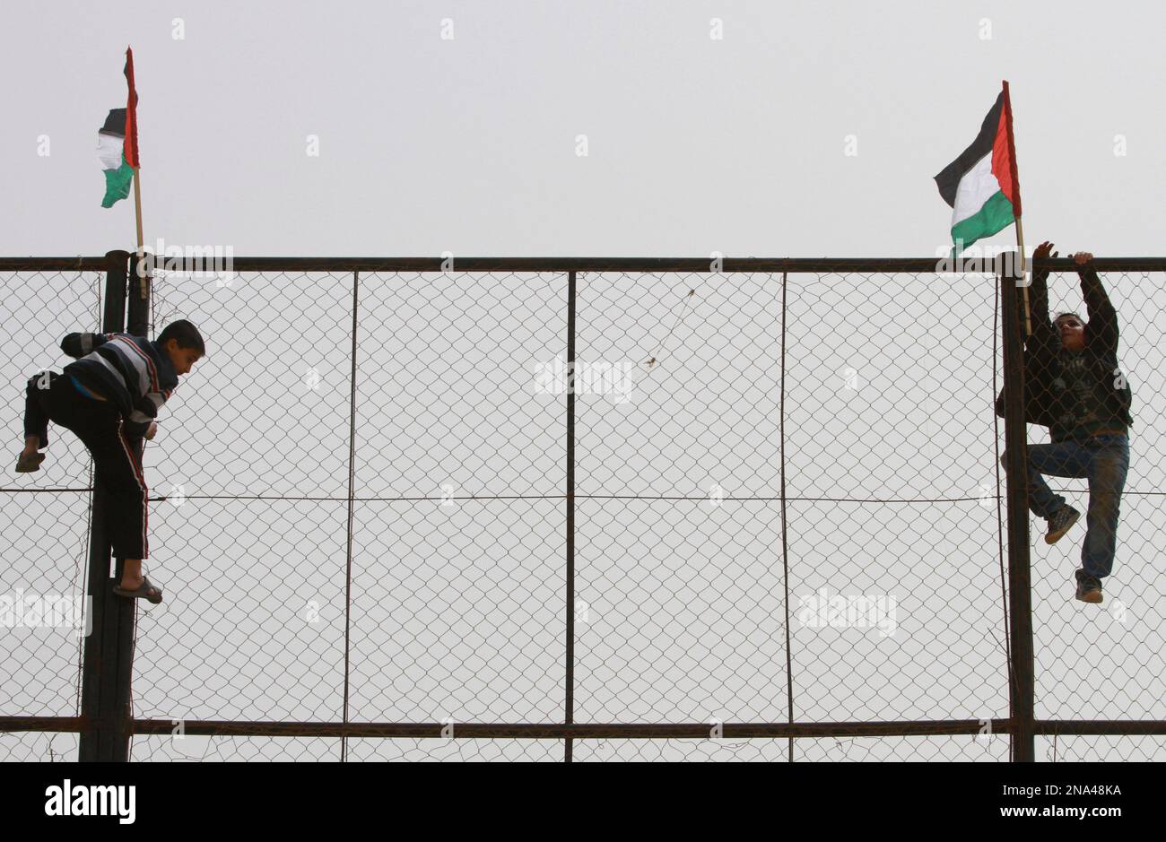 Palestinian children climb a playground fence during a rally demanding ...