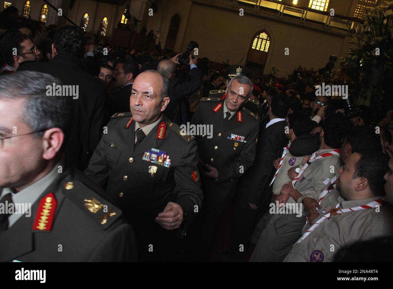 Egyptian generals from the ruling military council file out of the ...