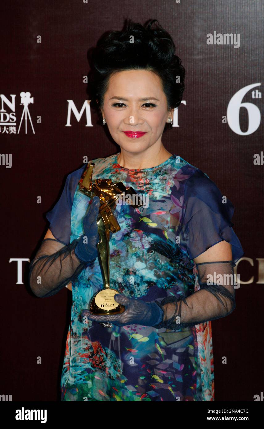 Hong Kong actress Deanie Yip poses with her trophy after receiving the ...