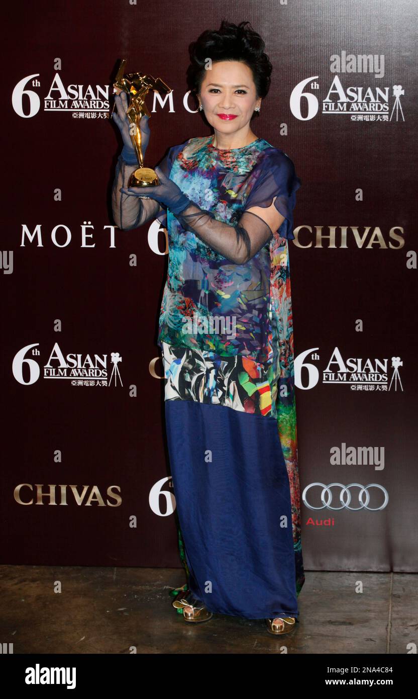 Hong Kong actress Deanie Yip poses with her trophy after receiving the ...