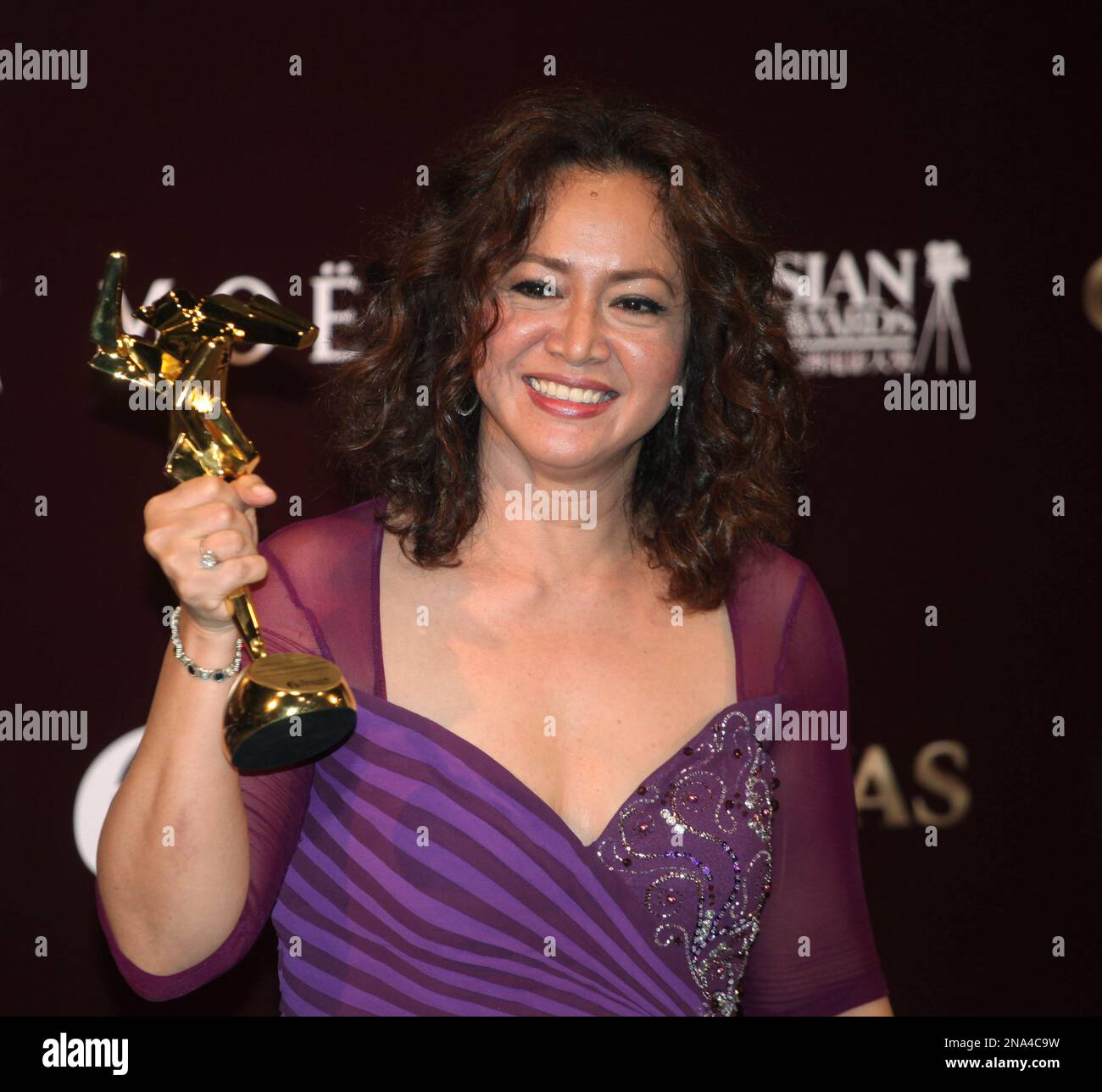 Philippine actress Sharmaine Buencamino poses with her trophy after ...