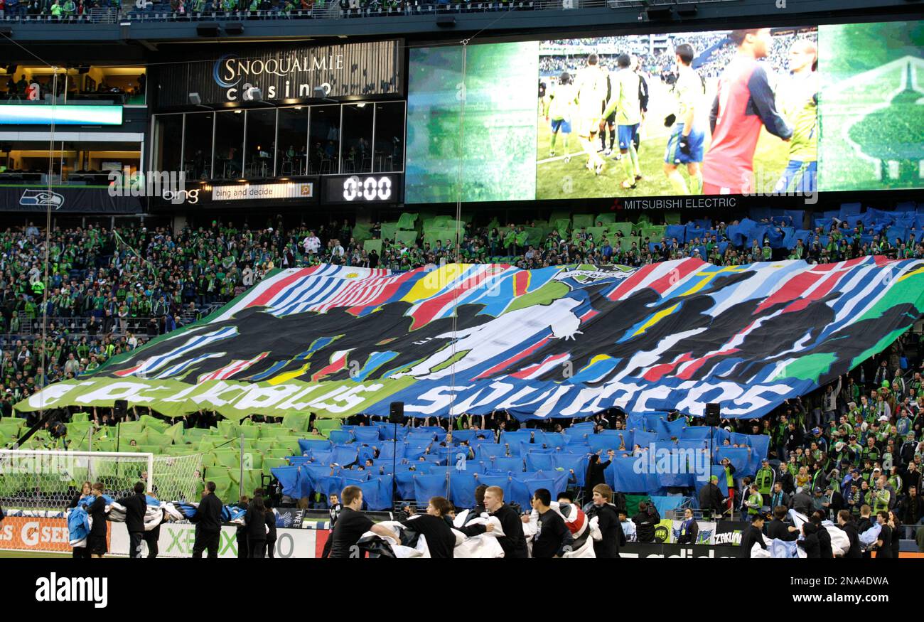 Seattle Sounders supporters show a tifo display featuring the flags of ...