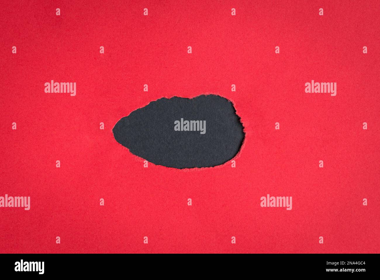 Torn red hole on black background. As template for message or ...