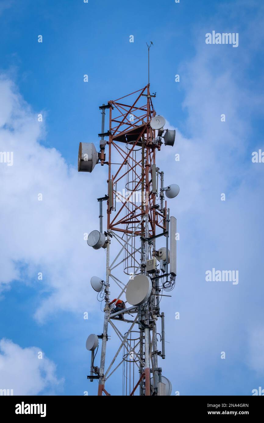 Telecommunication tower with blue and white clouds sky. Copy space ...