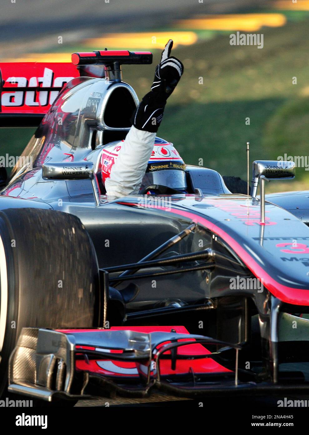McLaren driver Jenson Button of Britain celebrates after winning the ...