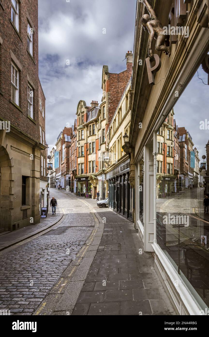 A narrow, cobbled street with window reflections, one of the few remaining areas of cobbled ...