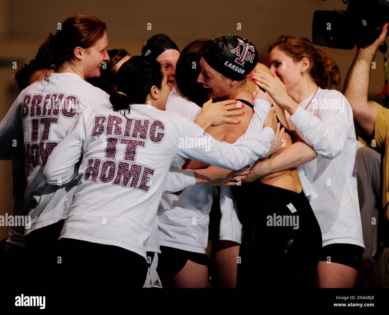 Texas A&M's Larson Breeja (black swimsuit) celebrates winning the 100 ...