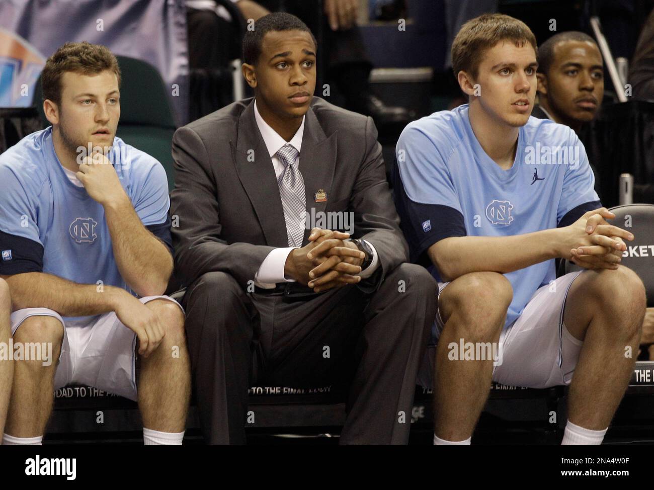 North Carolina's John Henson, center, sits on the bench during the ...