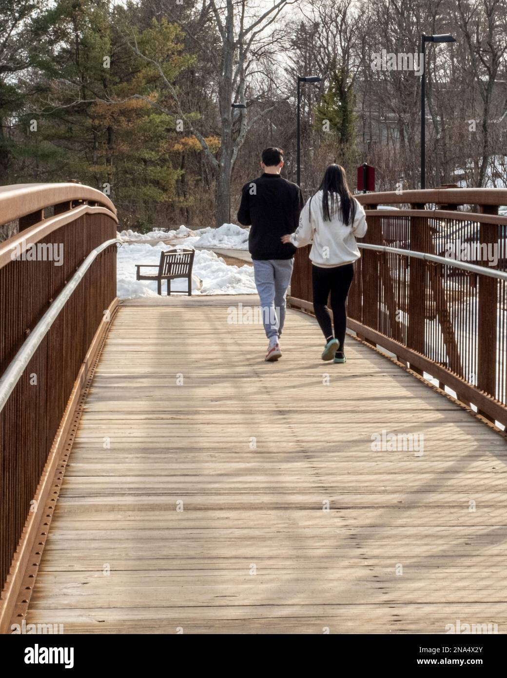 Couple walking across Brenner Bridge in Peterborough, New Hampshire ...