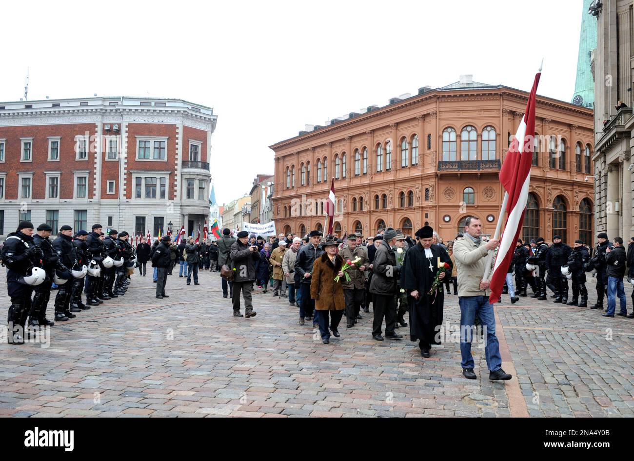 With Latvian flags, people march in a procession to the Freedom ...