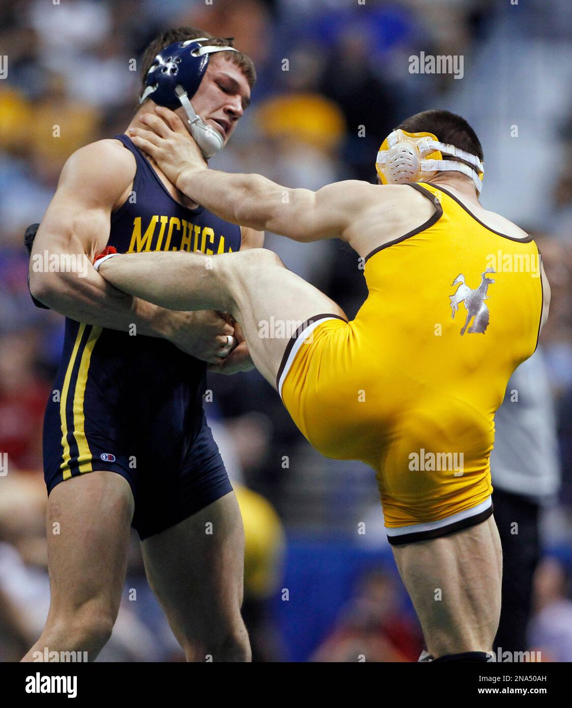 Michigan's Daniel Yates, left, competes with Wyoming's Shane Onufer ...