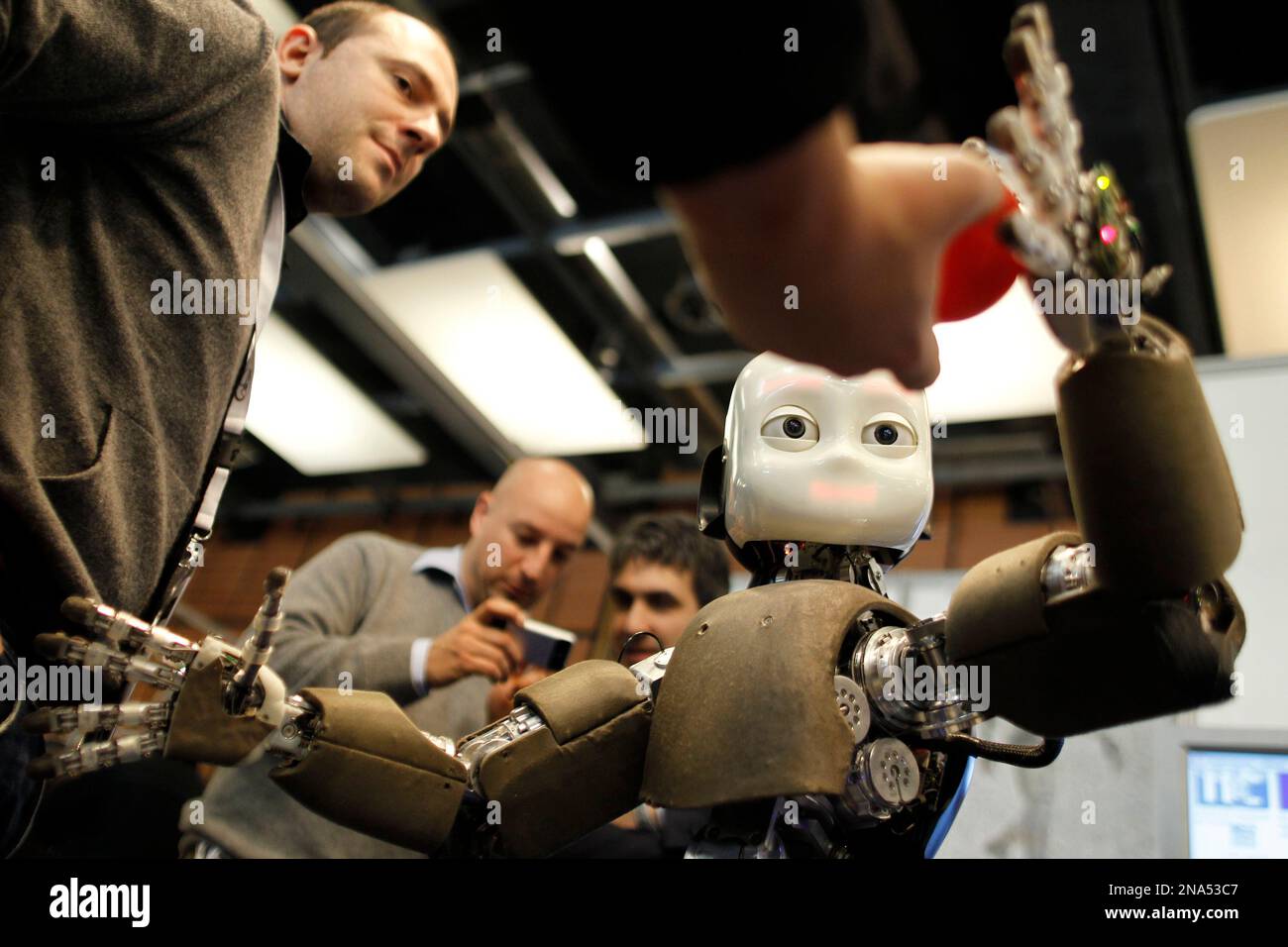 People look at the iCub robot during the Innorobo European summit, an ...