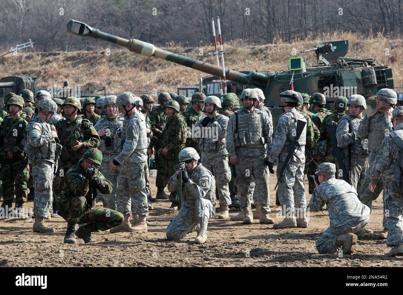 A South Korean and U.S. army soldier pose after a live fire drill ...