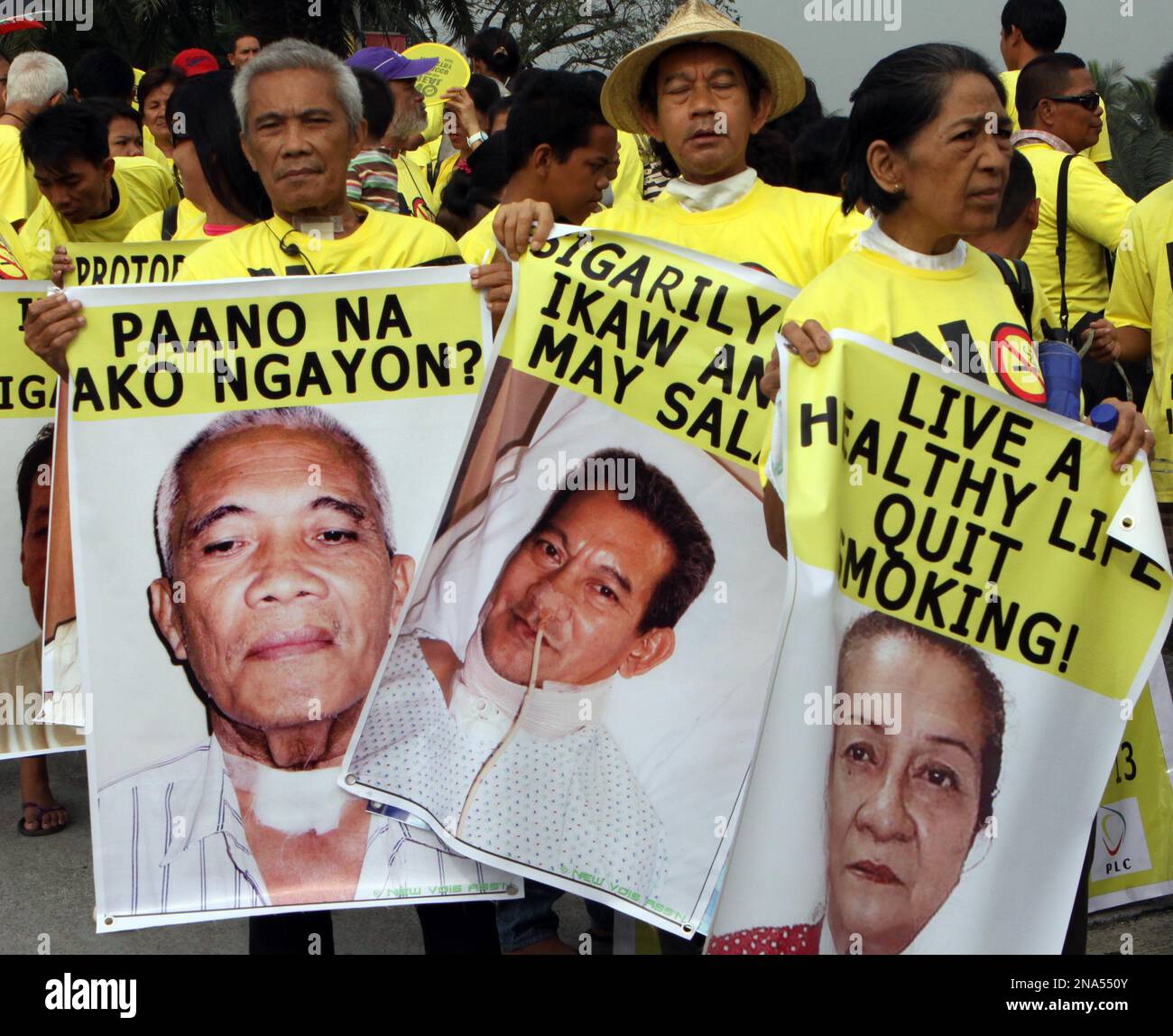 Victims of tobacco-related diseases holding their pictures, march ...