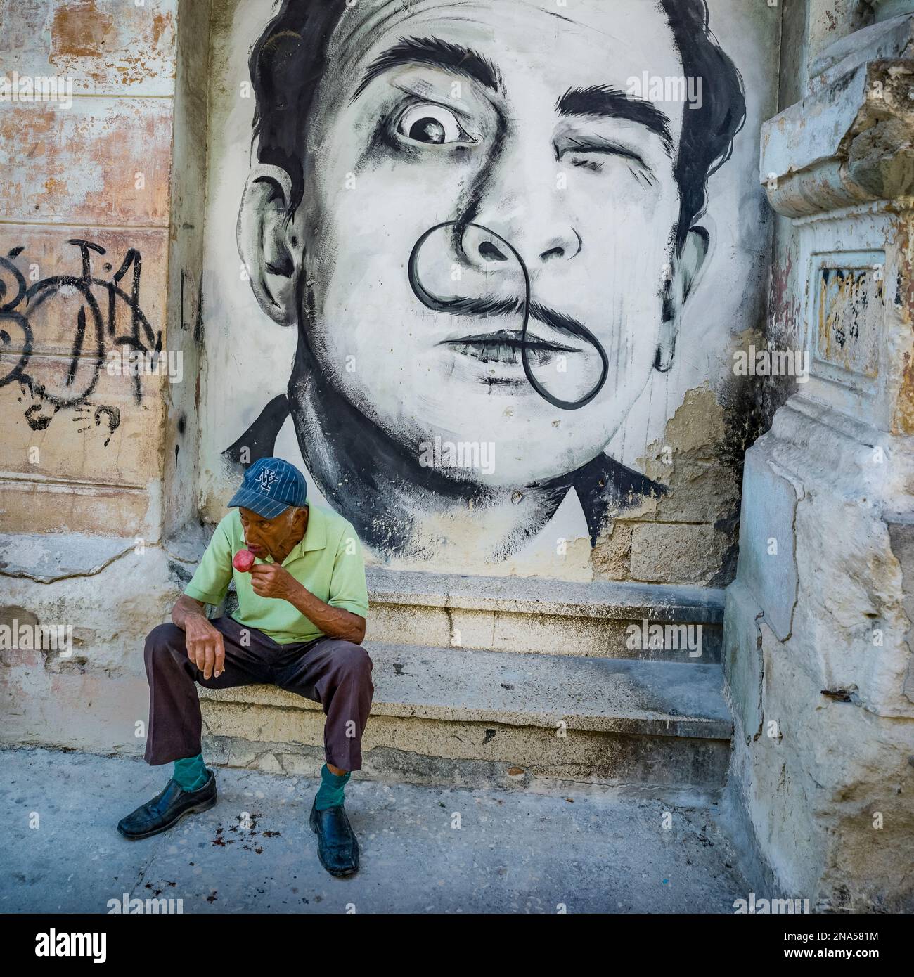 Portrait of a man painted on a stone wall along a street in Havana with ...