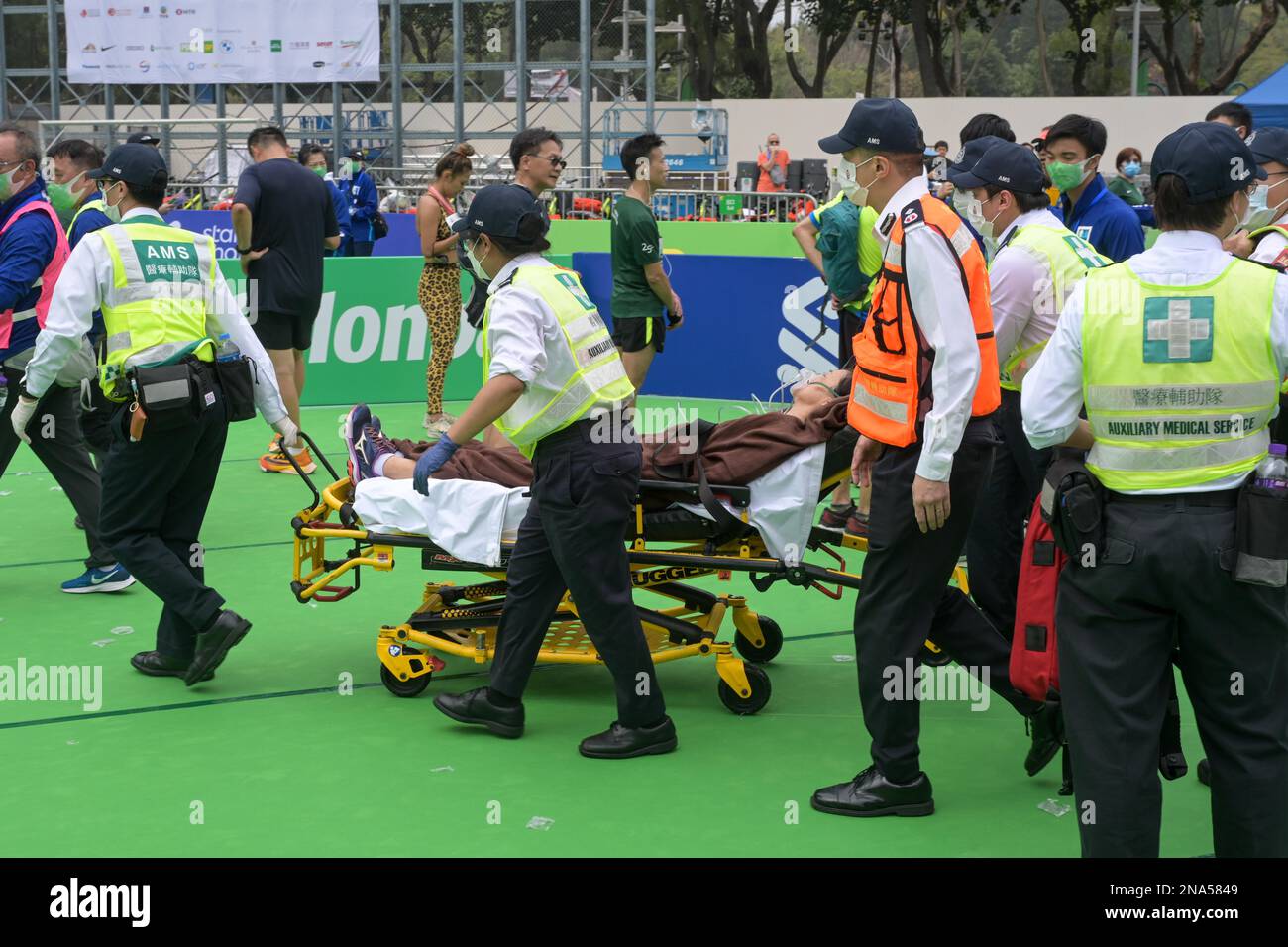 A runner is carried away on a stretcher by medical personnel at the ...
