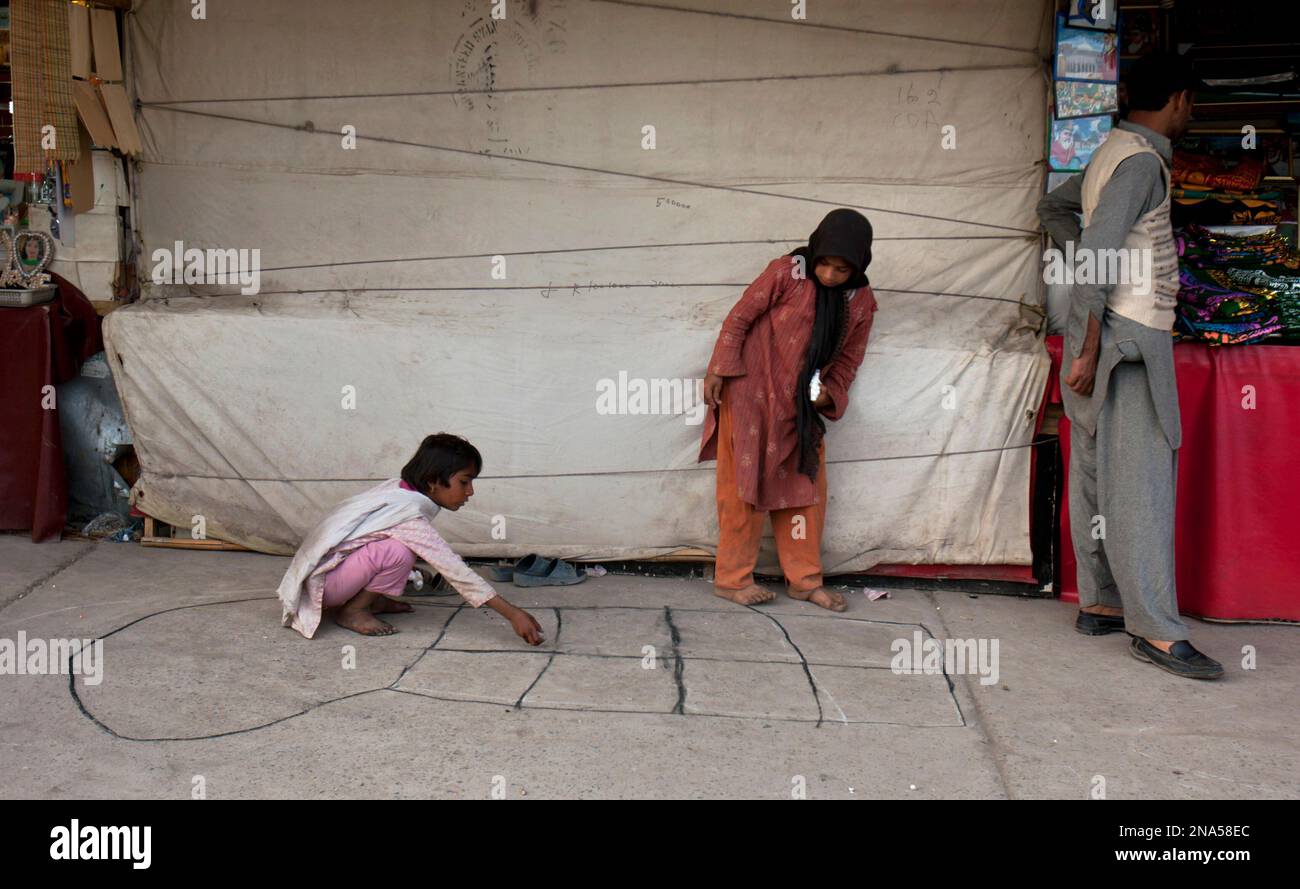 Pakistani girls, who sell shopping bags and sweets for a living, play ...