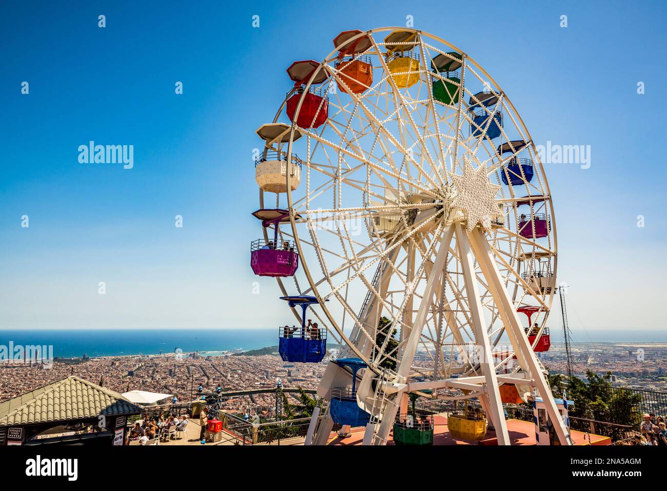 Amusement park with a colourful ferris wheel on Mount Tibidabo and a ...