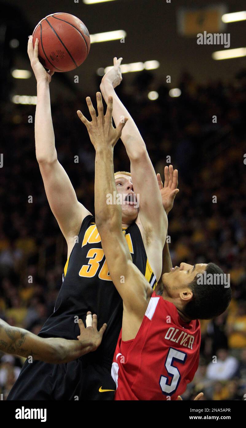 Iowa forward Aaron White shoots over Dayton forward Devin Oliver during ...