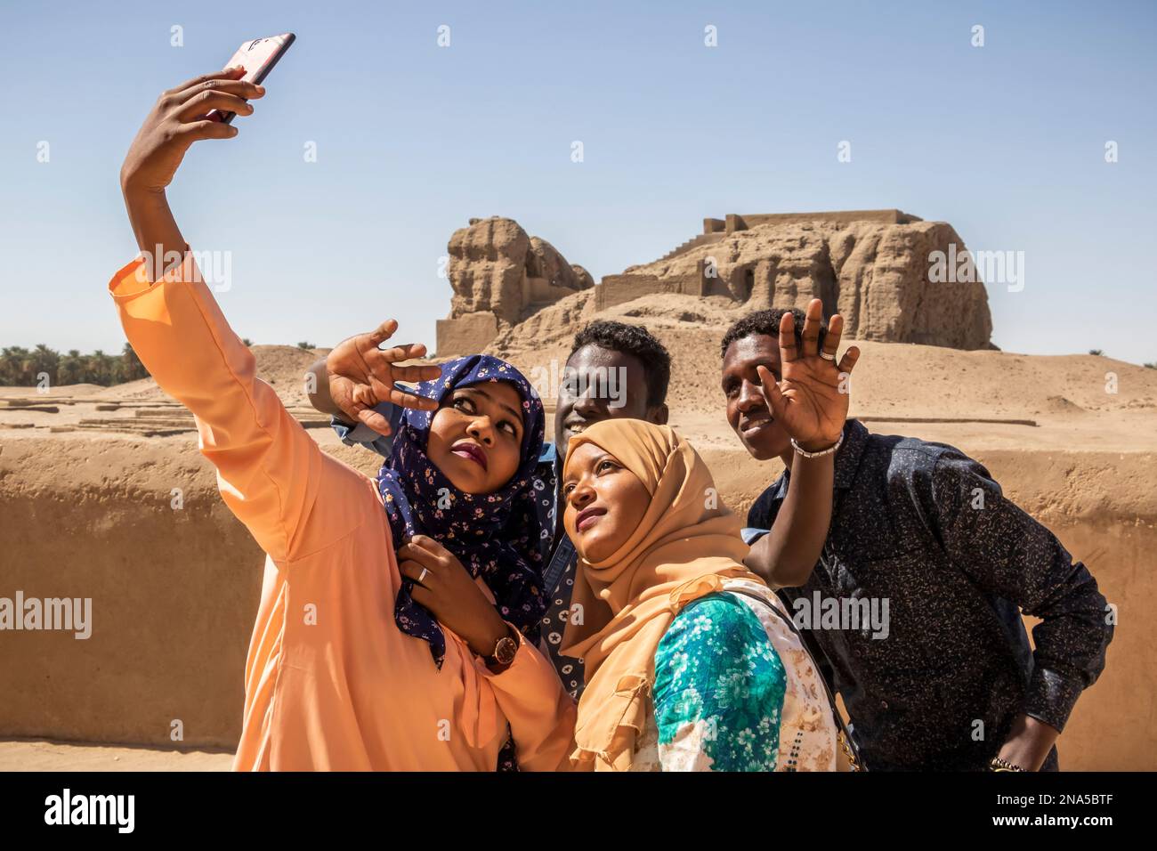 Sudanese students taking a self-portrait with a smart phone; Kerma ...