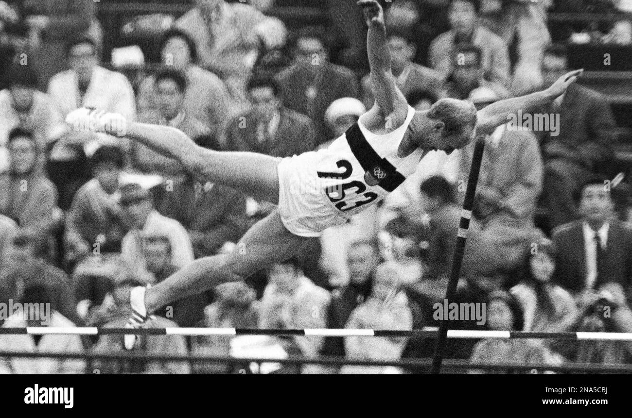 German athlete Willi Holdorf clears the bar in the pole vault ...