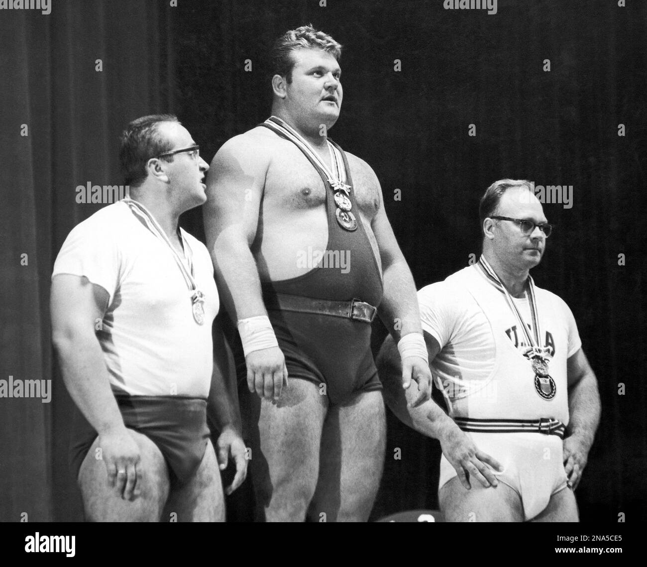 Standing on the winner’s platform during the awarding ceremonies are ...