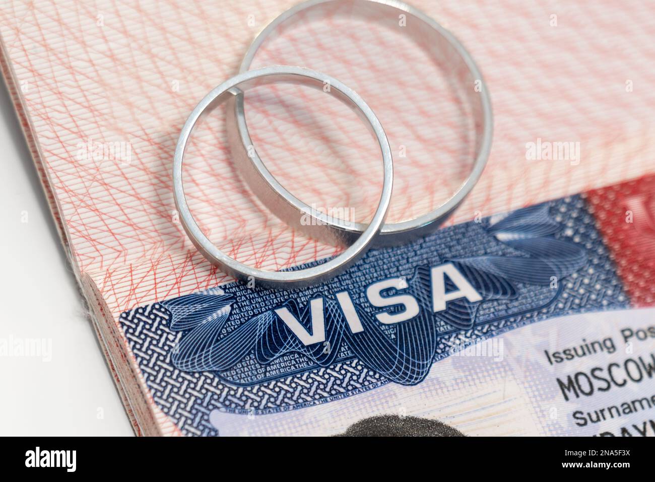 US visa and wedding rings on the passport as a symbol of international ...
