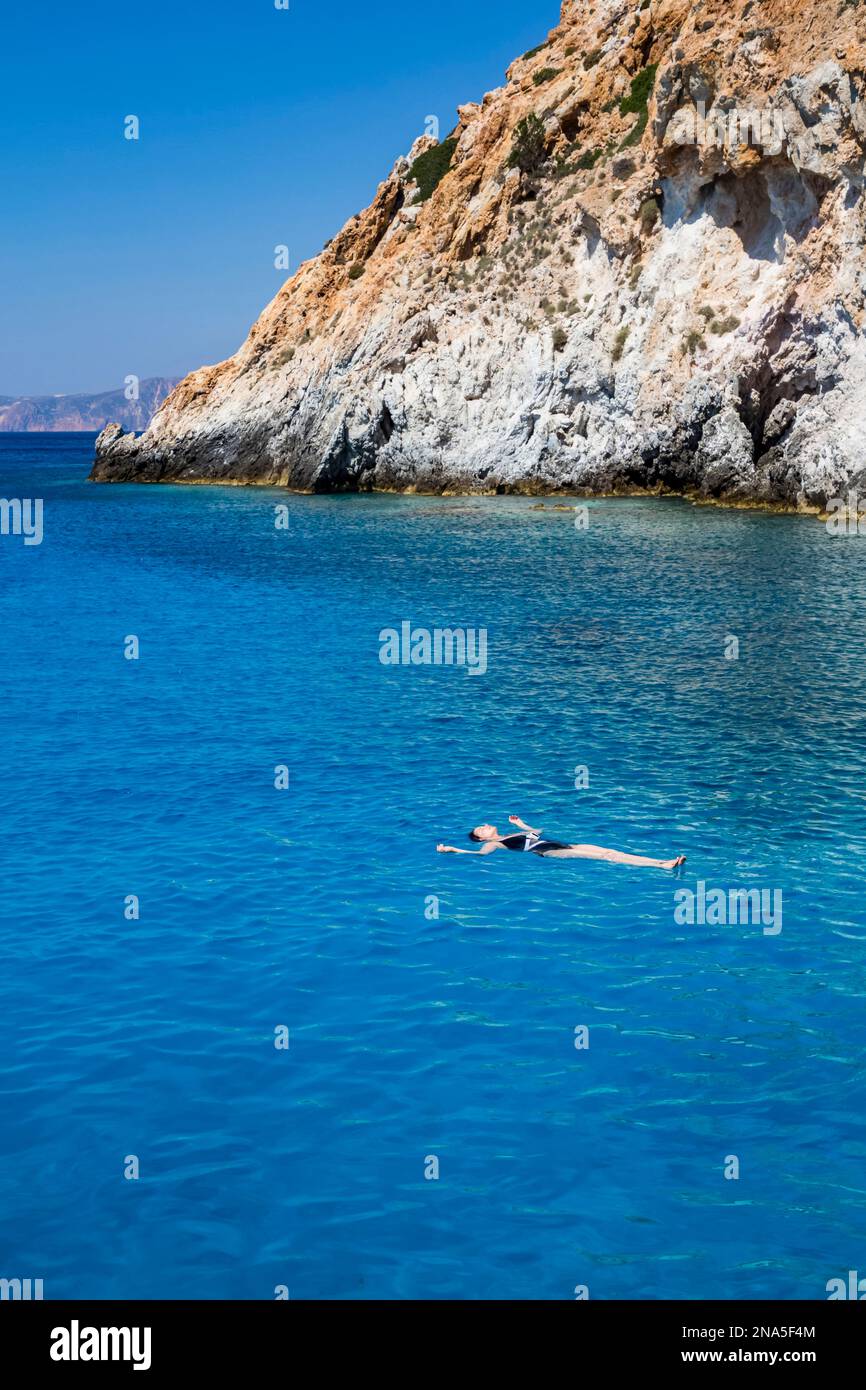 Tourist floating, Galazia Nera Bay; Polyaigos Island, Cyclades, Greece ...