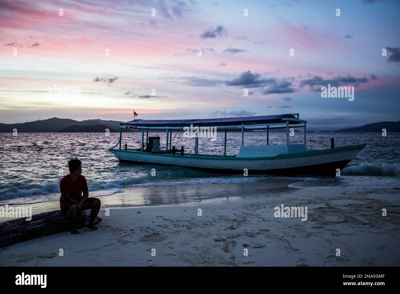 Boat on the beach at sunset, Pulau Kelelawar (Bat Island); West Papua ...