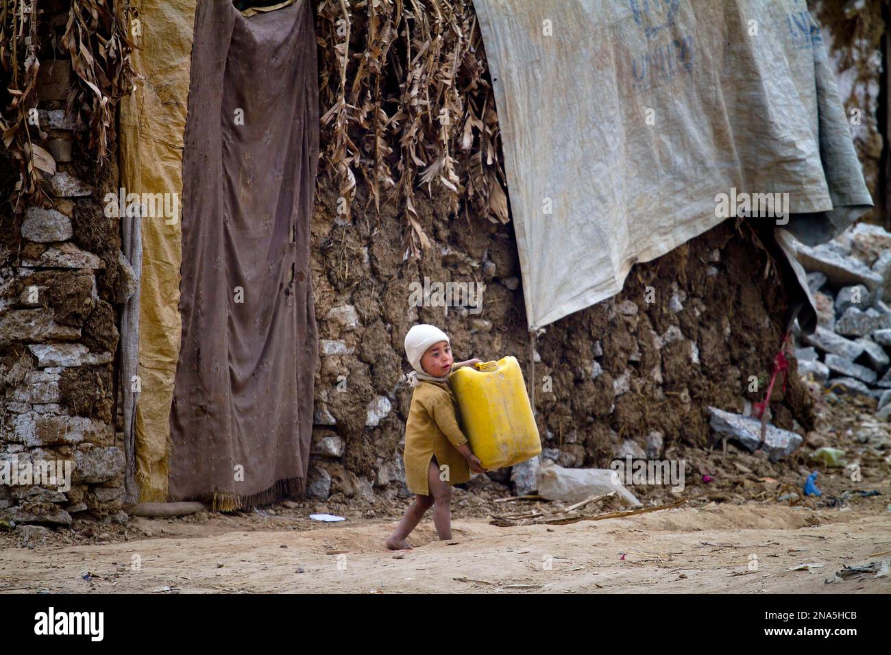 A child from Pakistan's Bajur tribal region, plays with an empty water ...