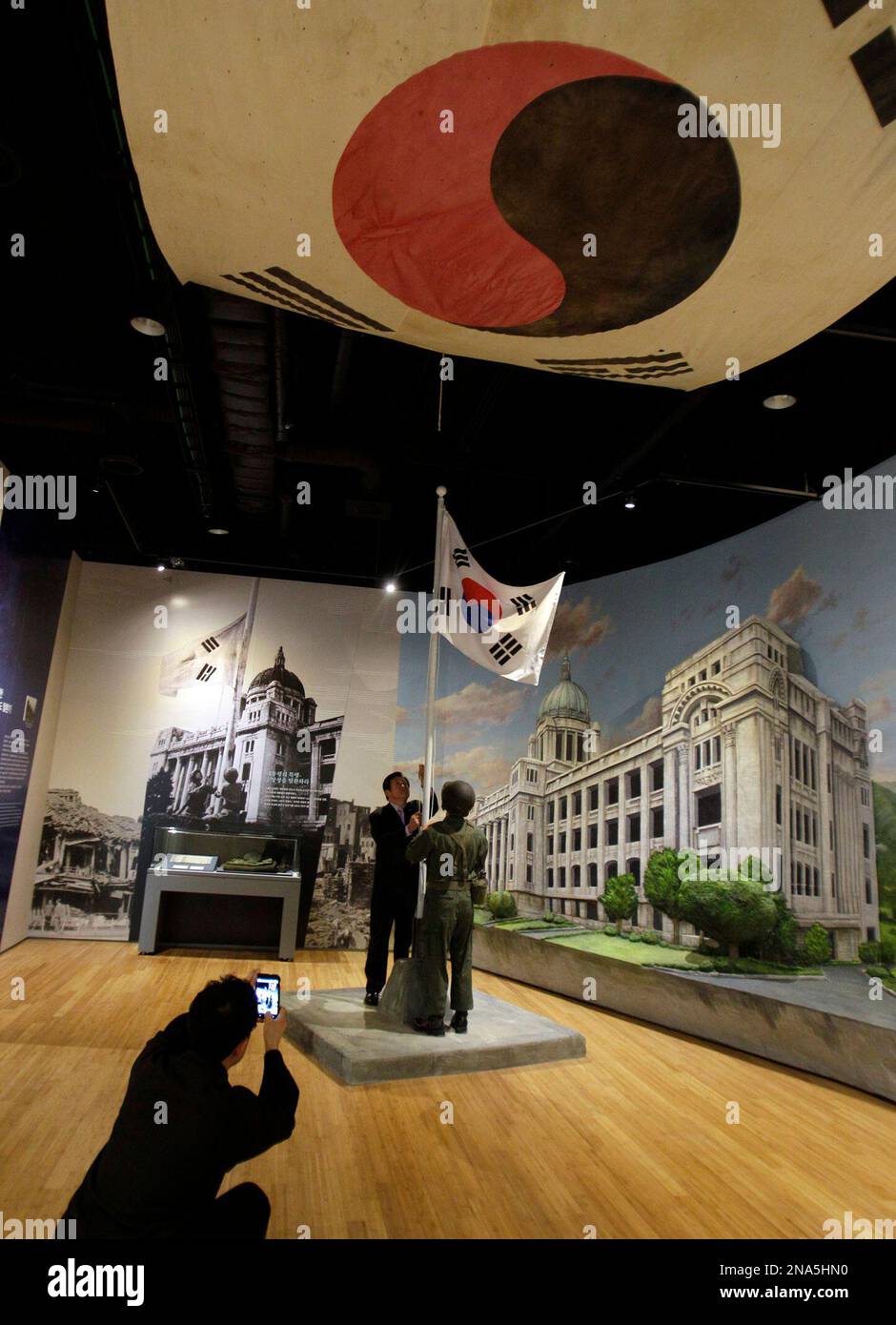 Visitors take souvenir pictures with the monument in remembrance of the ...