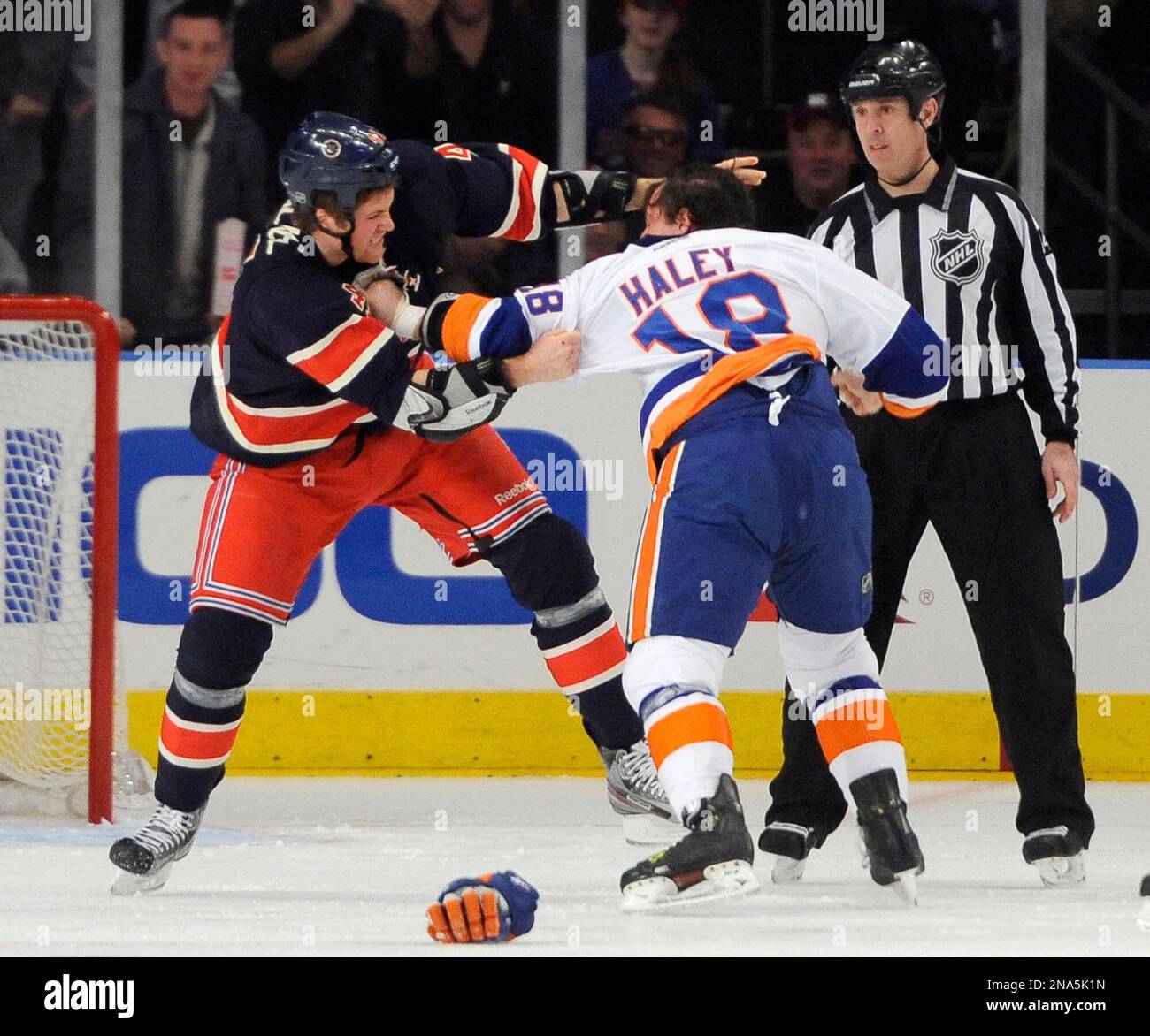 New York Rangers' Stu Bickel, left, fights with New York Islanders ...