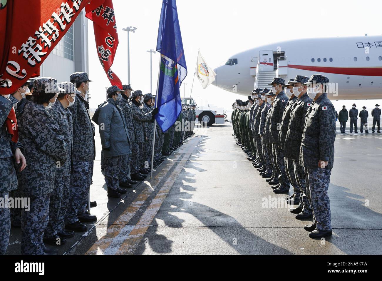Japan Air Self-Defense Force personnel line up before boarding a ...