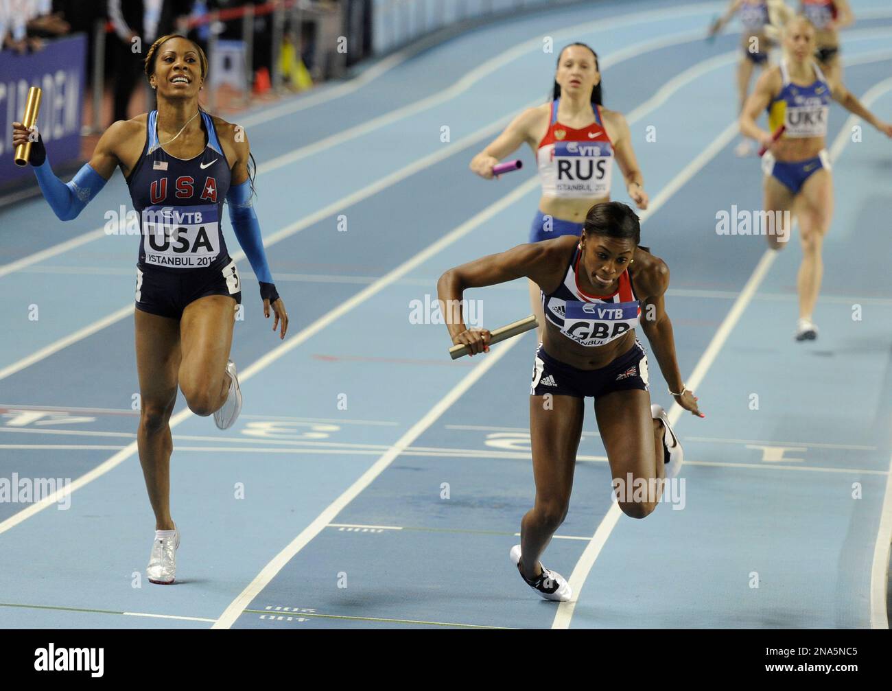 Britain's Perri Shakes-Drayton, right, crosses the finish line ahead of ...