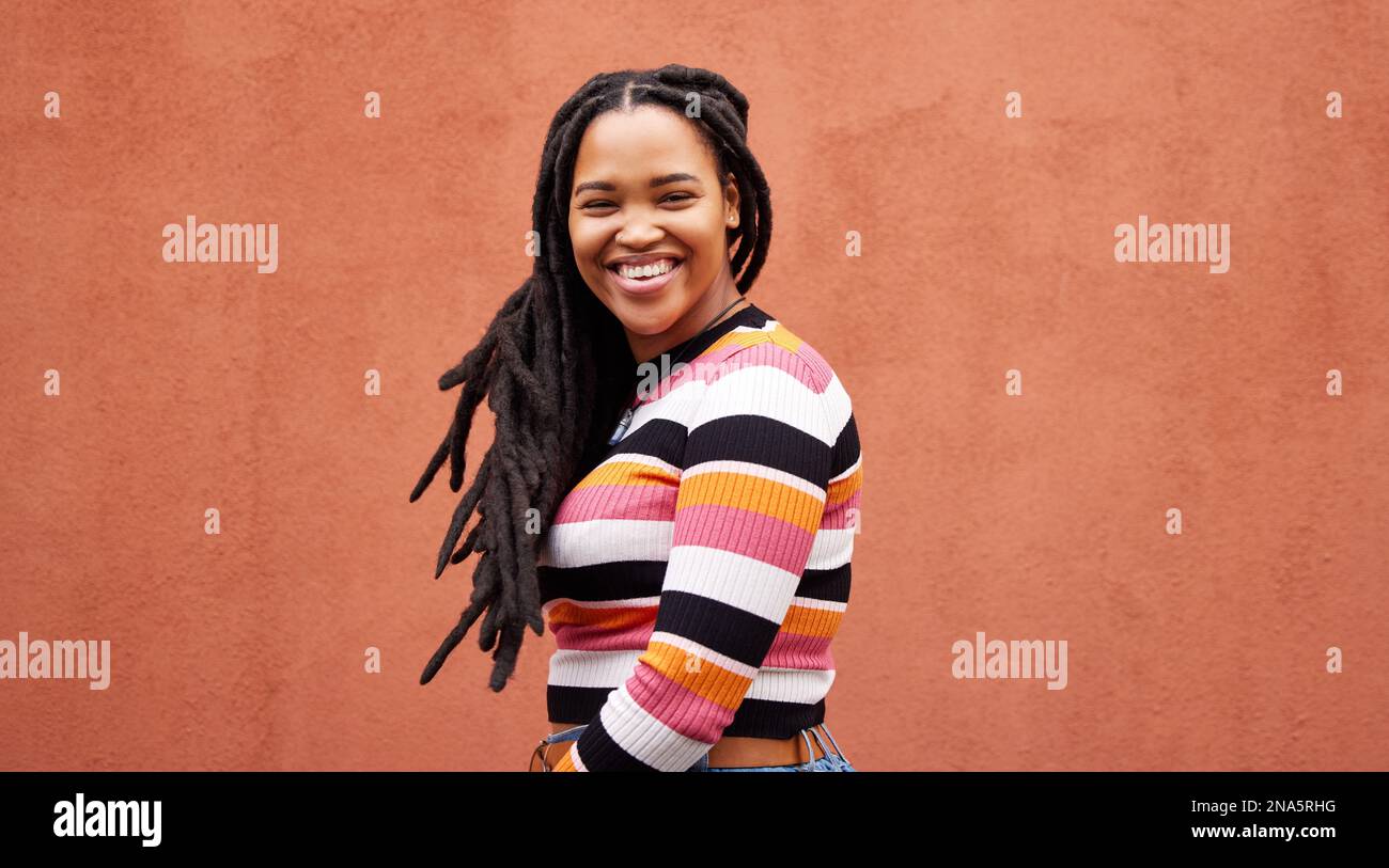 Portrait, wall and black woman with smile, fashion and freedom with joy ...