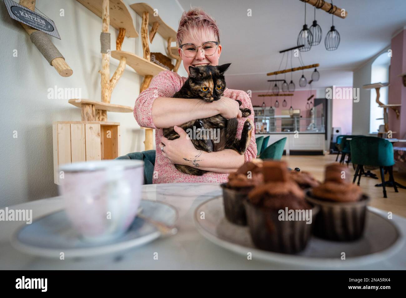Chemnitz, Germany. 09th Feb, 2023. With cat "Elfriede" on her lap ...