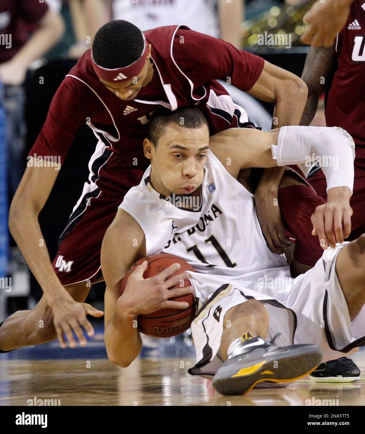 St. Bonaventure's Demetrius Conger (11) holds onto the ball as he falls ...