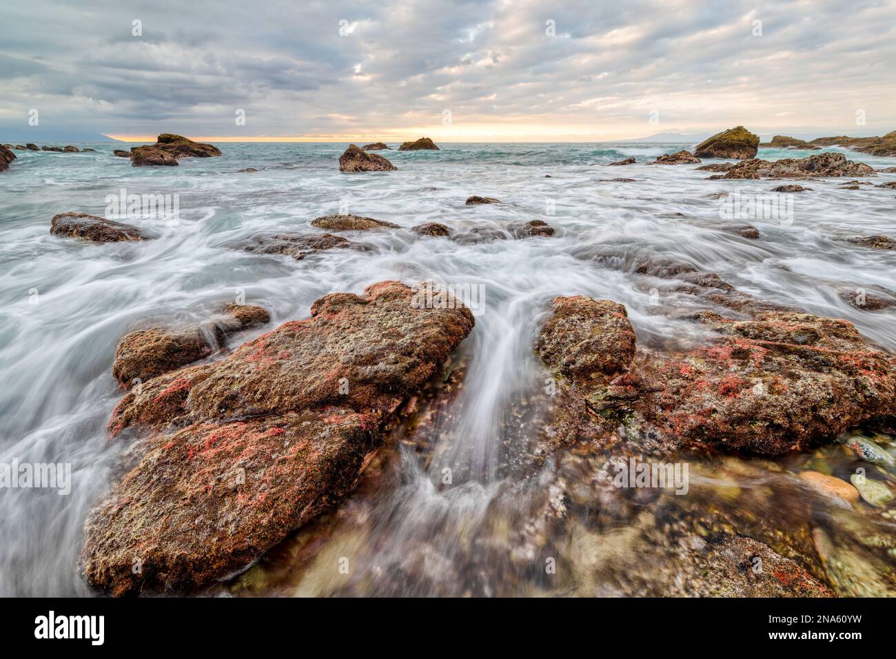 An Inspirational Ocean Sunset With Details In The Rocks And A Soft ...