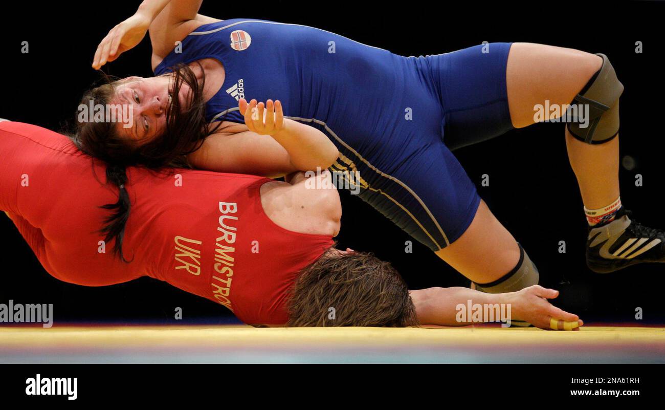 Ukraine's Kateryna Burmistrova, down, grapples with Norway's Maja Gunvor Erlandsen during their ...
