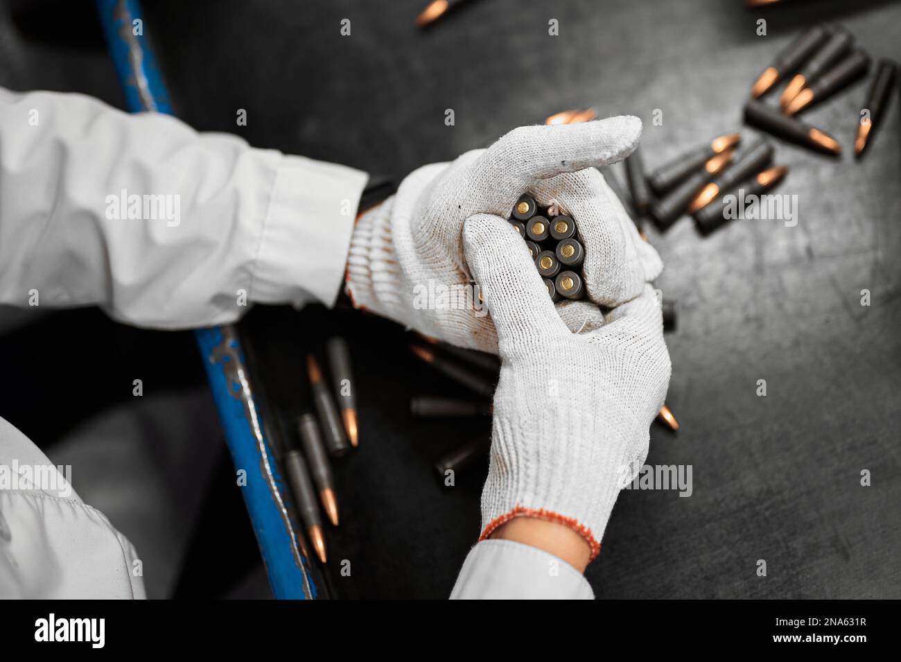 Sorting and selective quality control of weapon cartridges. Hands of ...
