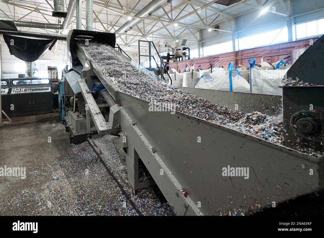 Chopped waste plastic transported by production line Stock Photo - Alamy