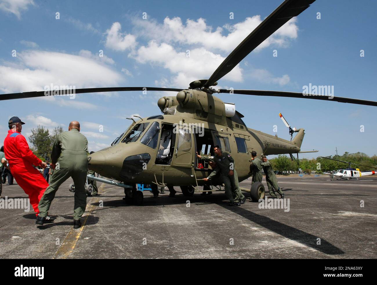 A Polish aircraft mechanic, left, and Philippine Air Force crew, prepare a brand new Polish ...