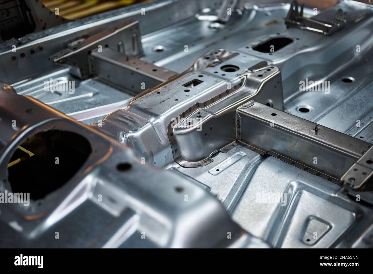 Shiny metal car body element in assembling workshop Stock Photo - Alamy