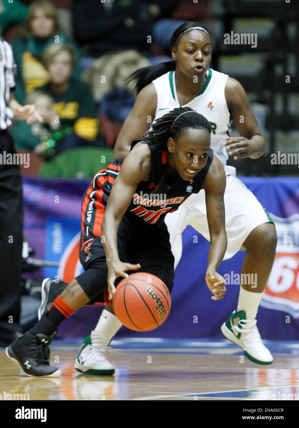 Texas Tech guard Chynna Brown (00) dribbles upcourt as she is defended ...