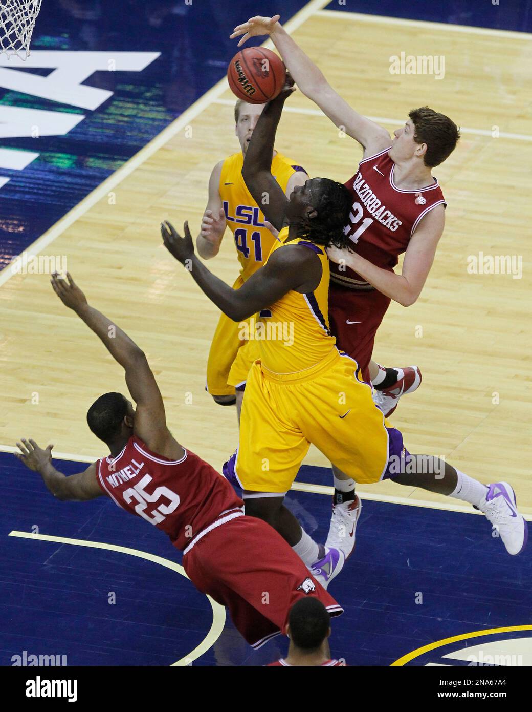 Arkansas forward Hunter Mickelson (21) blocks the shot of LSU forward ...