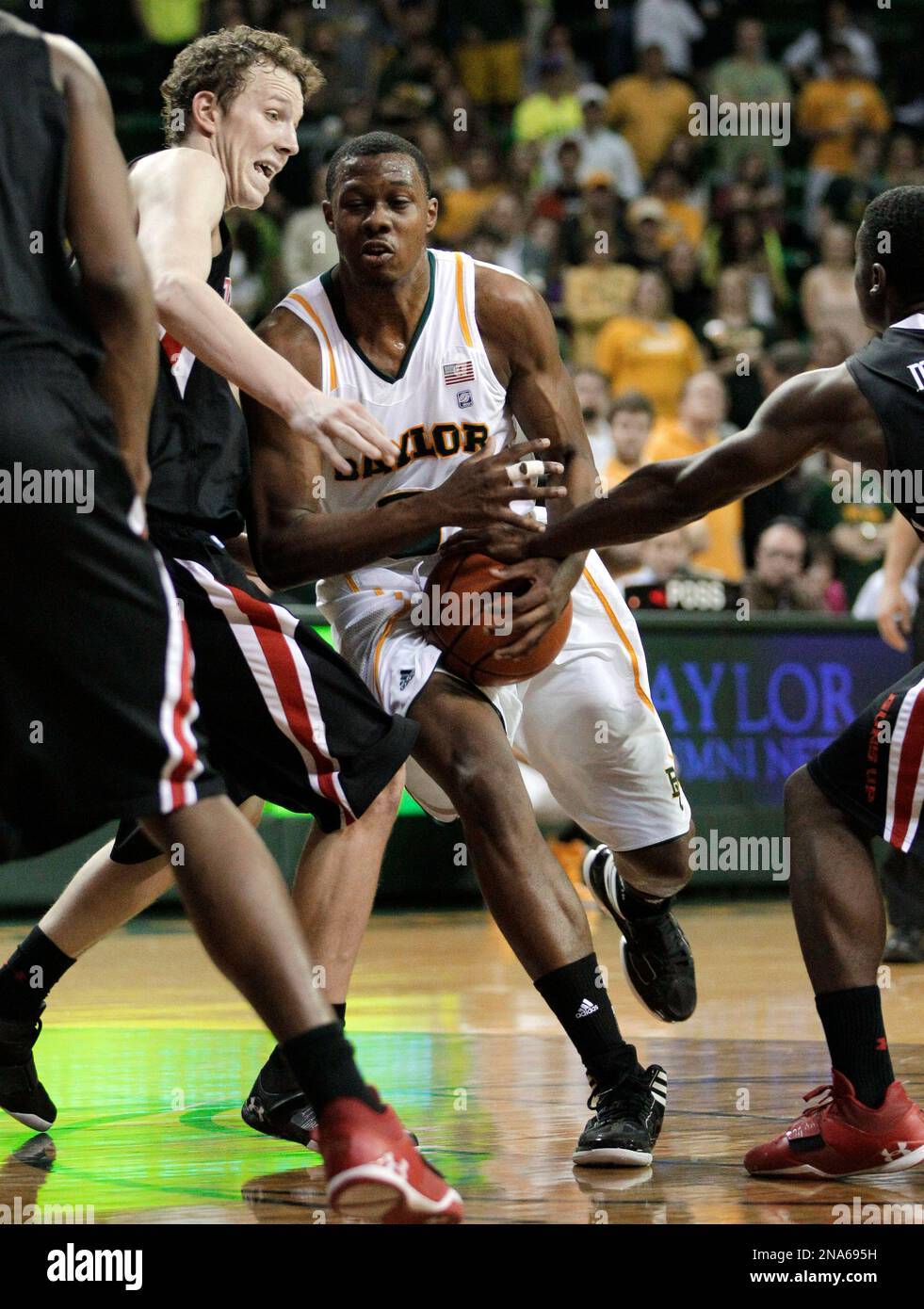 Baylor forward Fred Ellis (3) drives through Texas Tech defenders ...