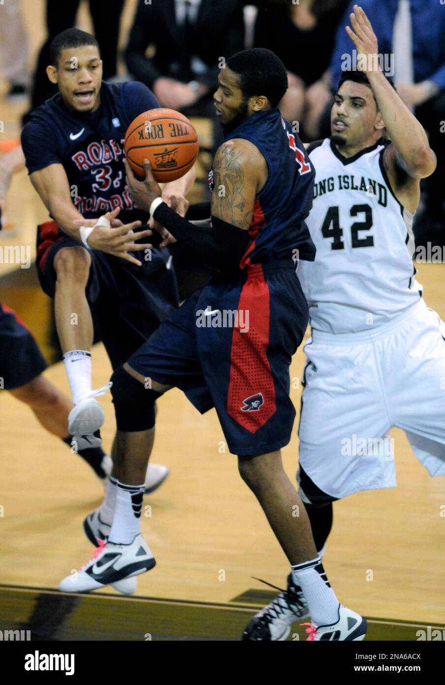 Robert Morris' Russell Johnson, left, and Mike McFadden, center, battle ...