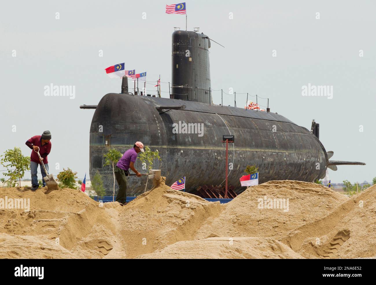 Workers at construction site shovel sand with the decommissioned Agosta ...