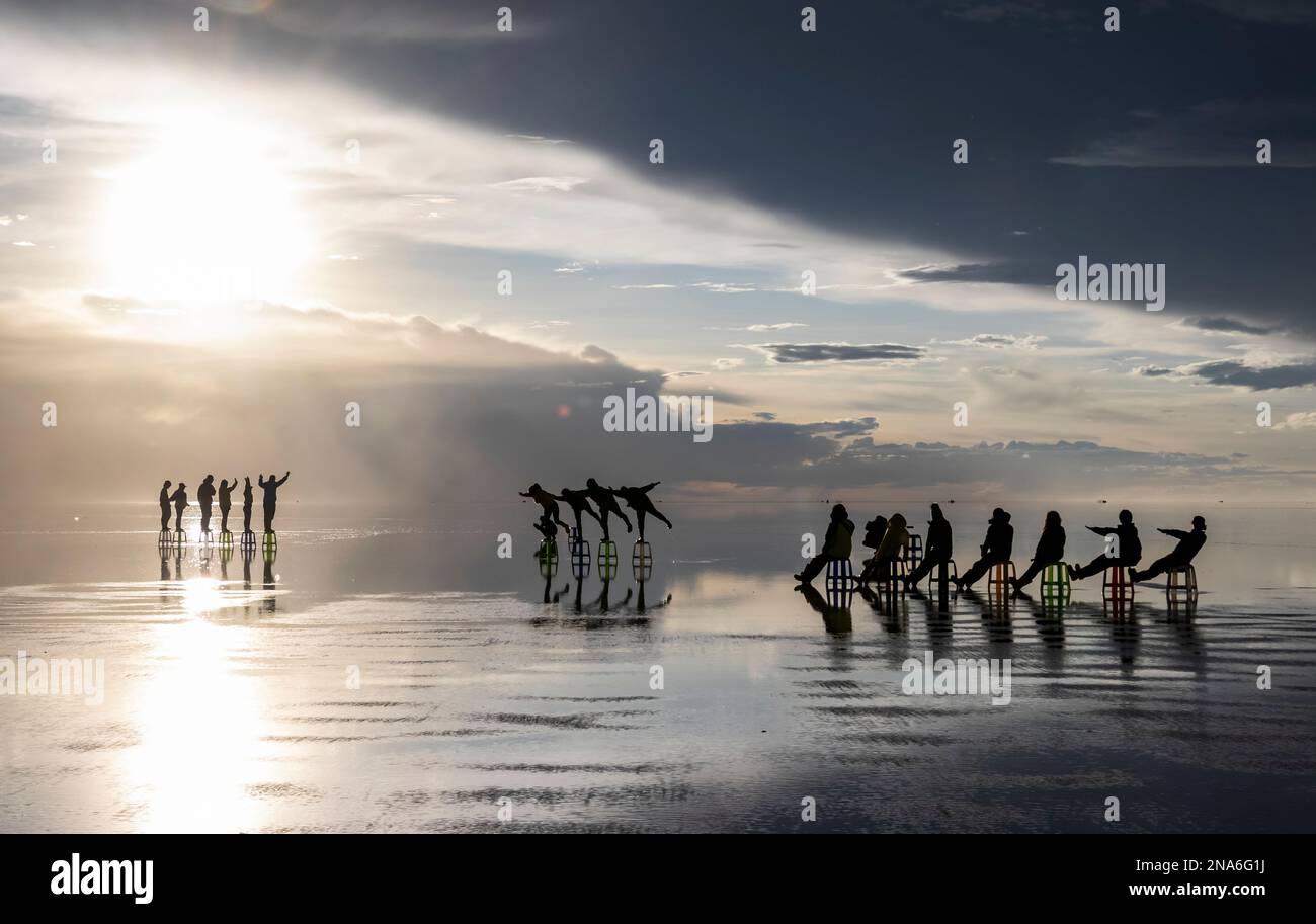 Tourists posing in the reflection during the wet season (December ...